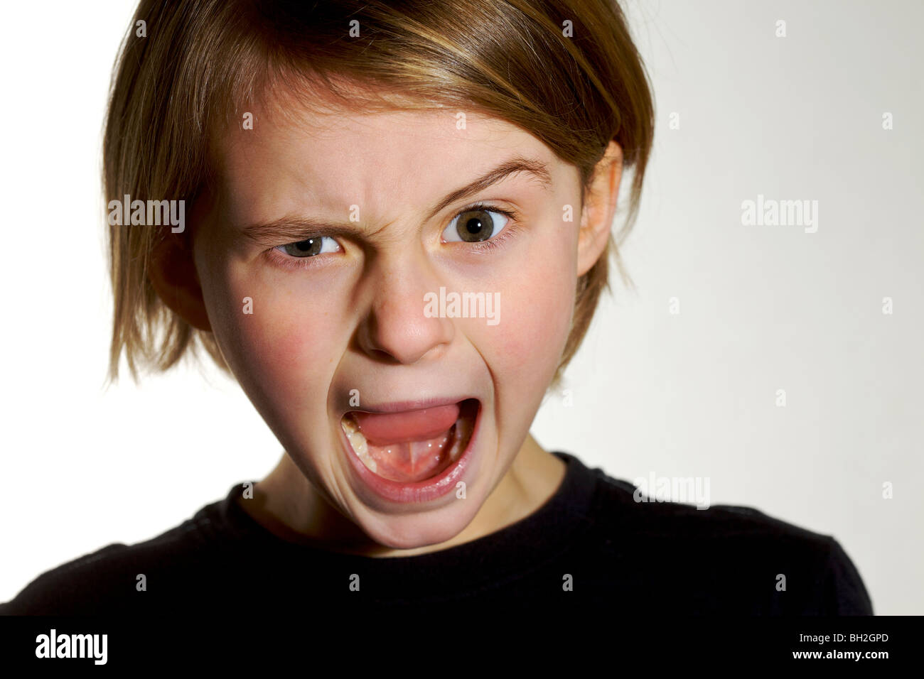 Young girl shouting screaming shocked alarmed scared surprised ...