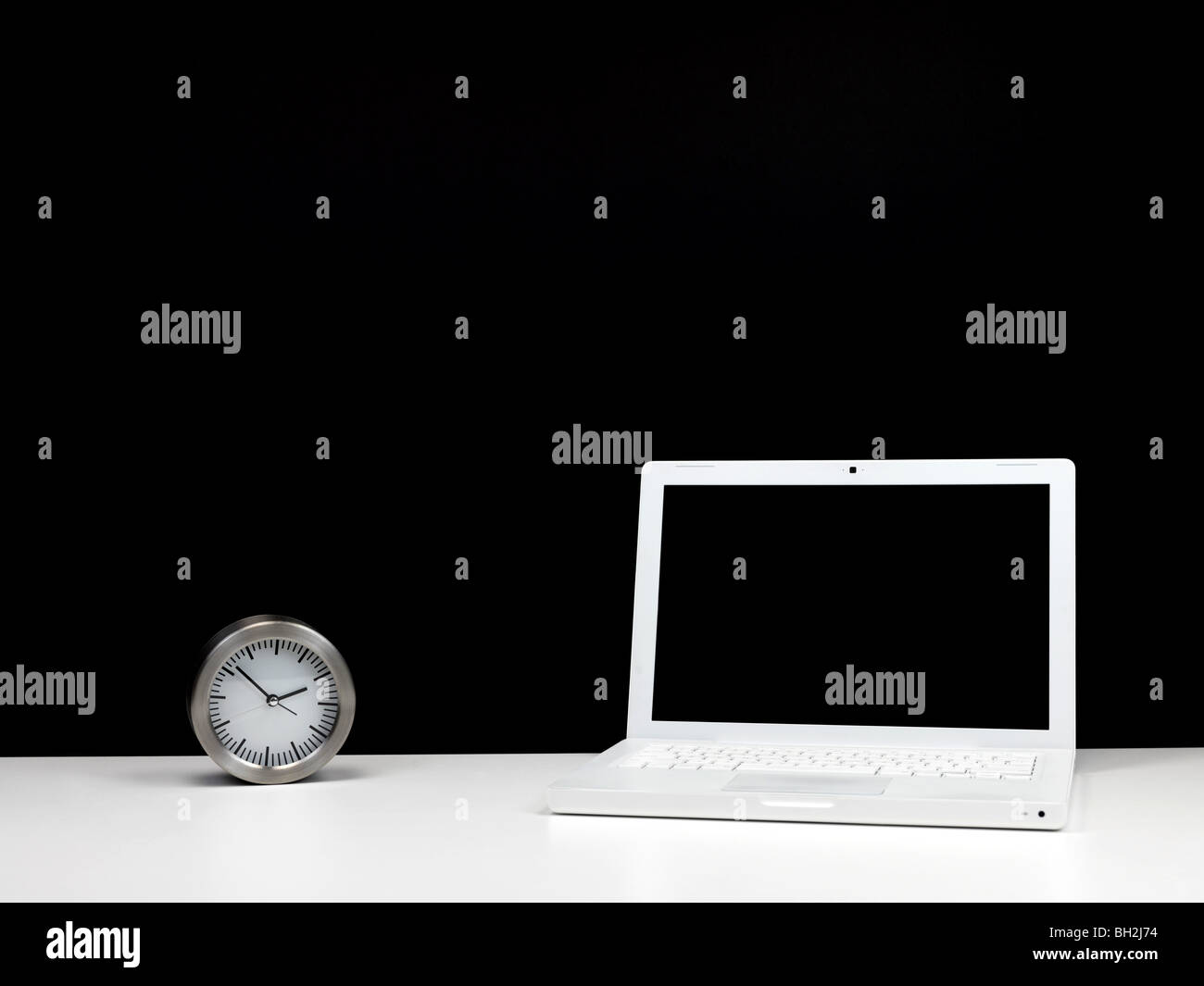 A contemporary workplace office desk with a black background Stock ...