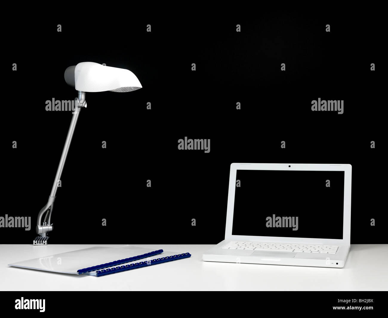 A contemporary workplace office desk with a black background Stock ...