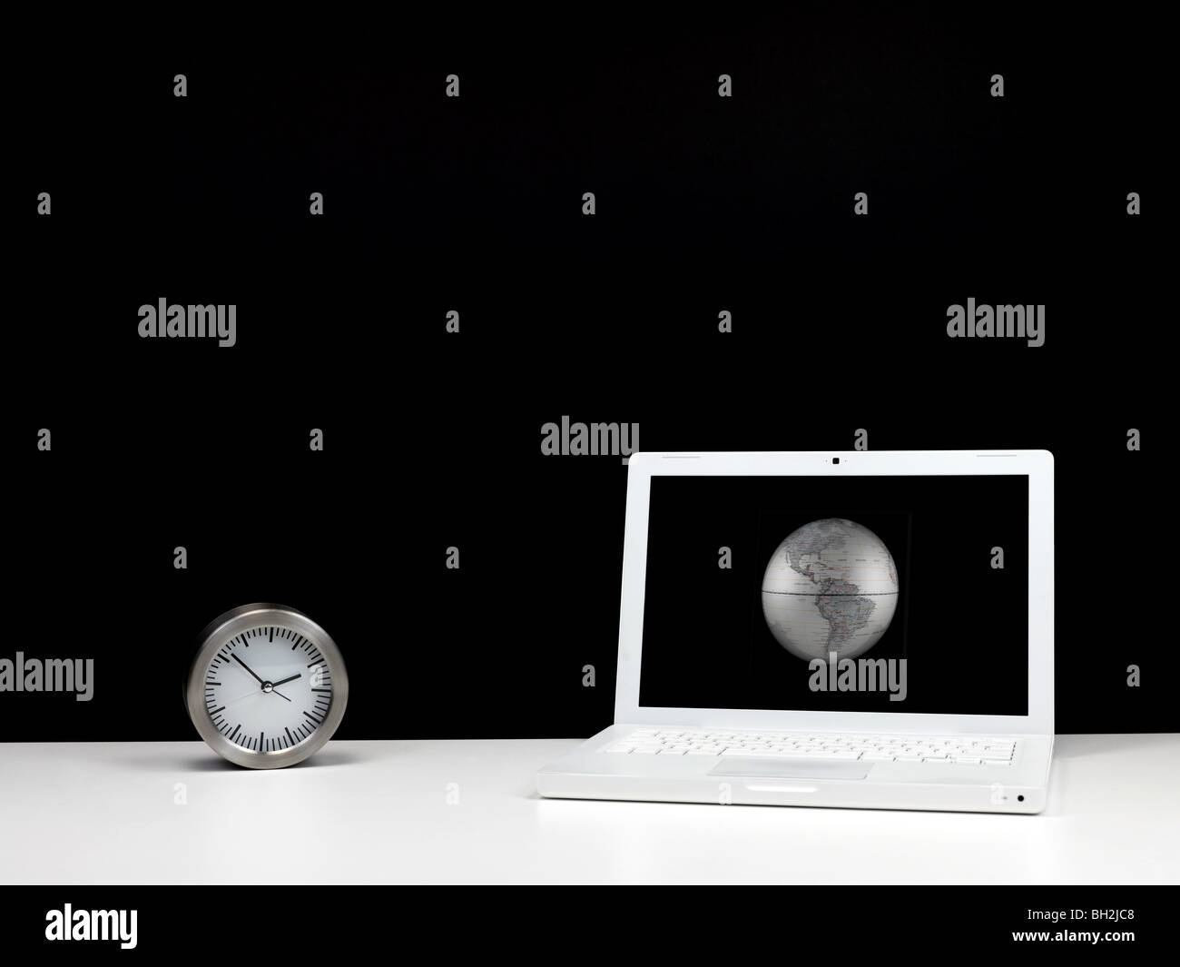 A contemporary workplace office desk with a black background Stock ...