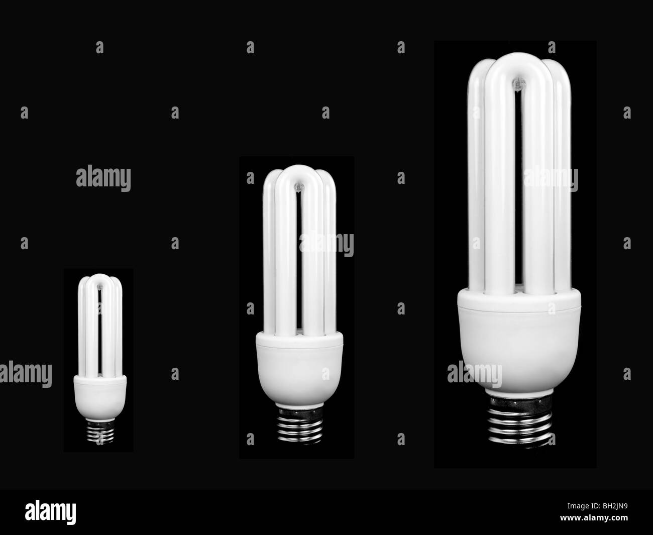 An energy saving light bulb isolated against a black background Stock ...