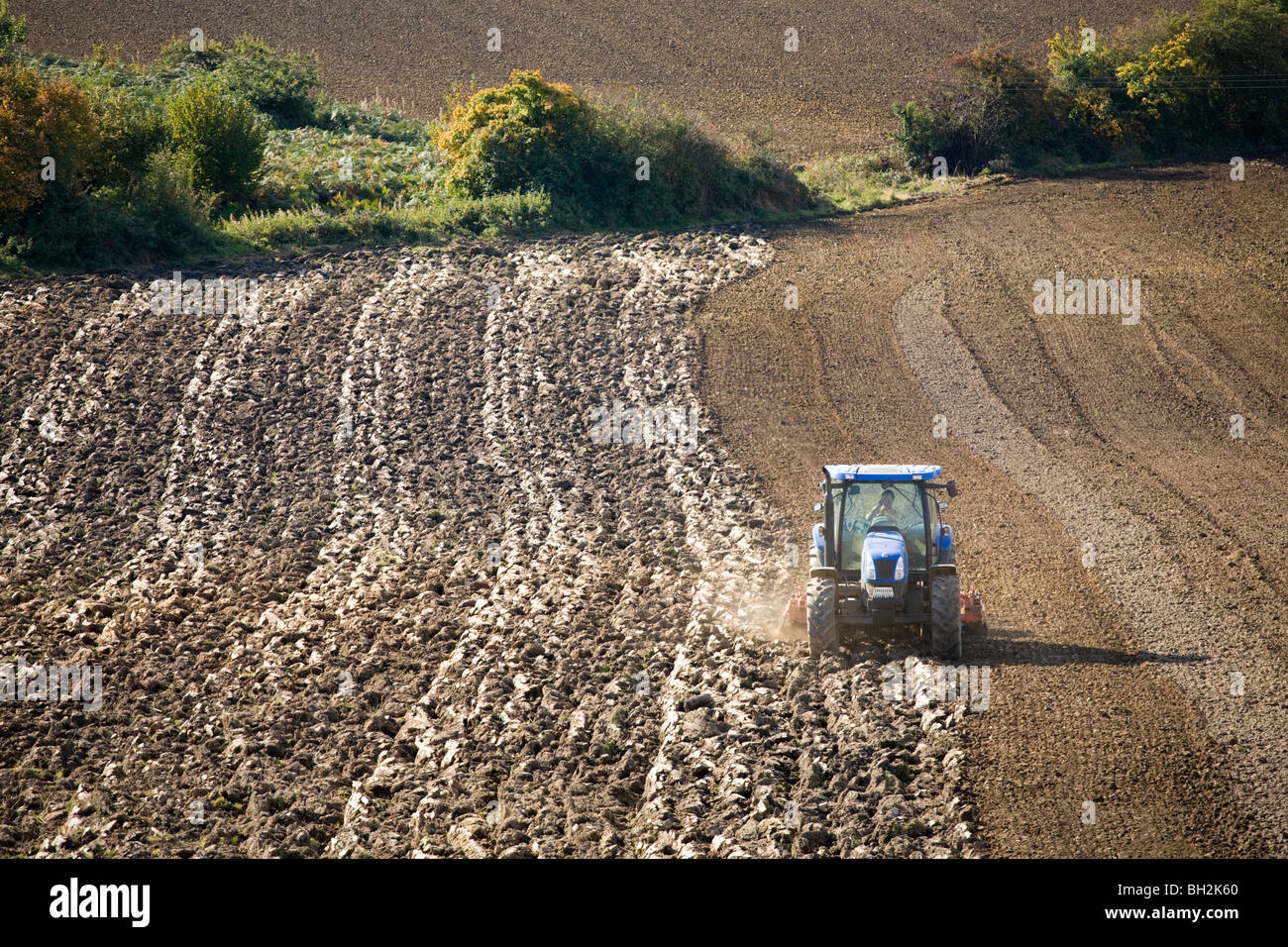 Tractor ploughing field Stock Photo - Alamy