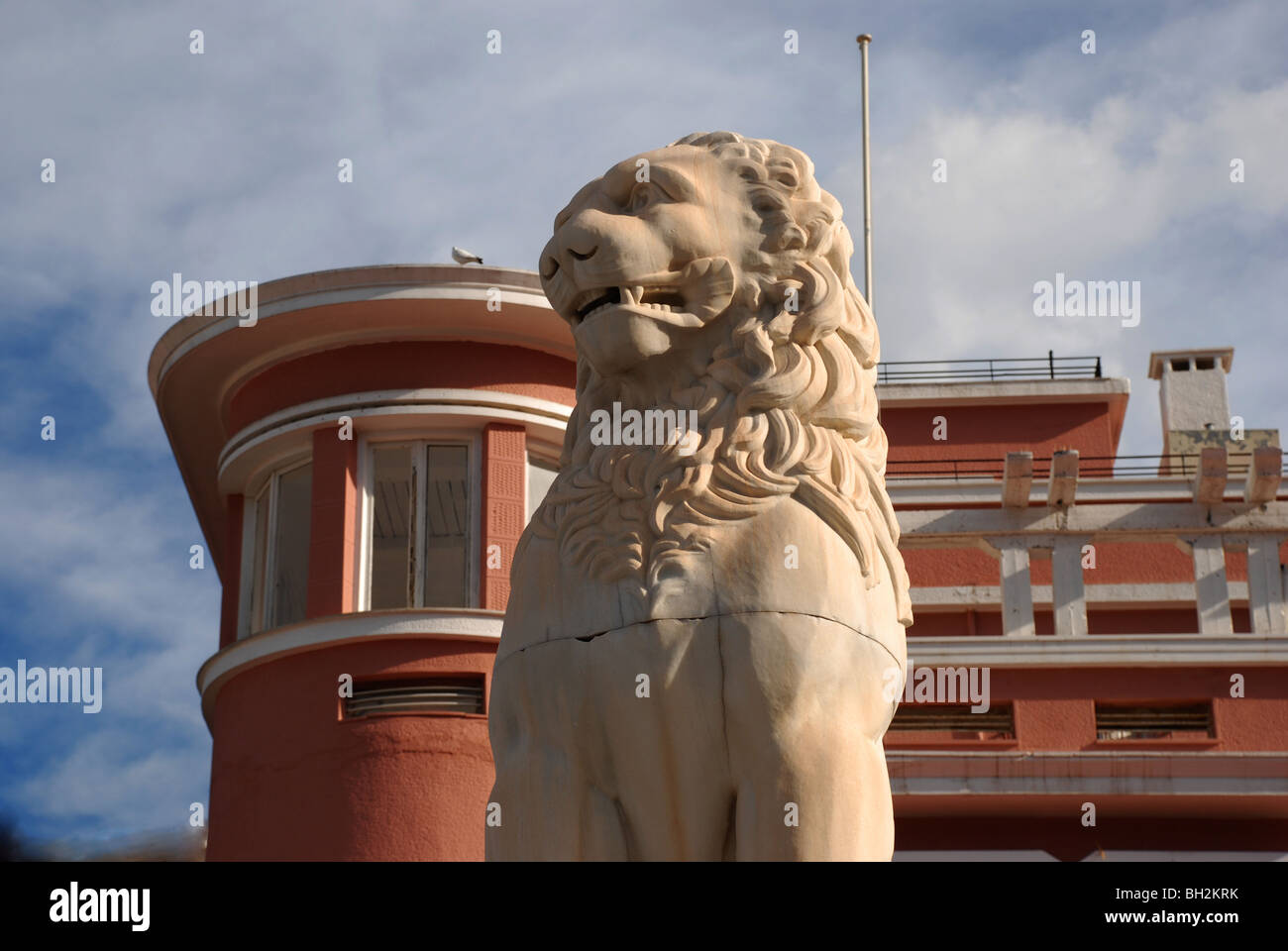 statue of a lion in front of pink building Stock Photo - Alamy