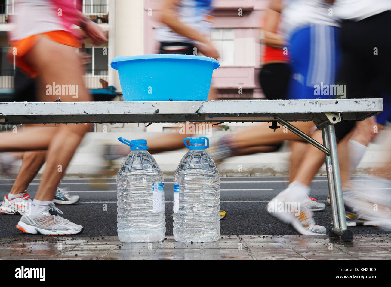 Marathon runners at water station at 2010 Las Palmas city marathon ...