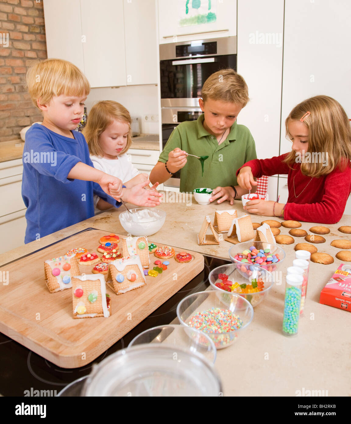 four kids baking cookies Stock Photo - Alamy