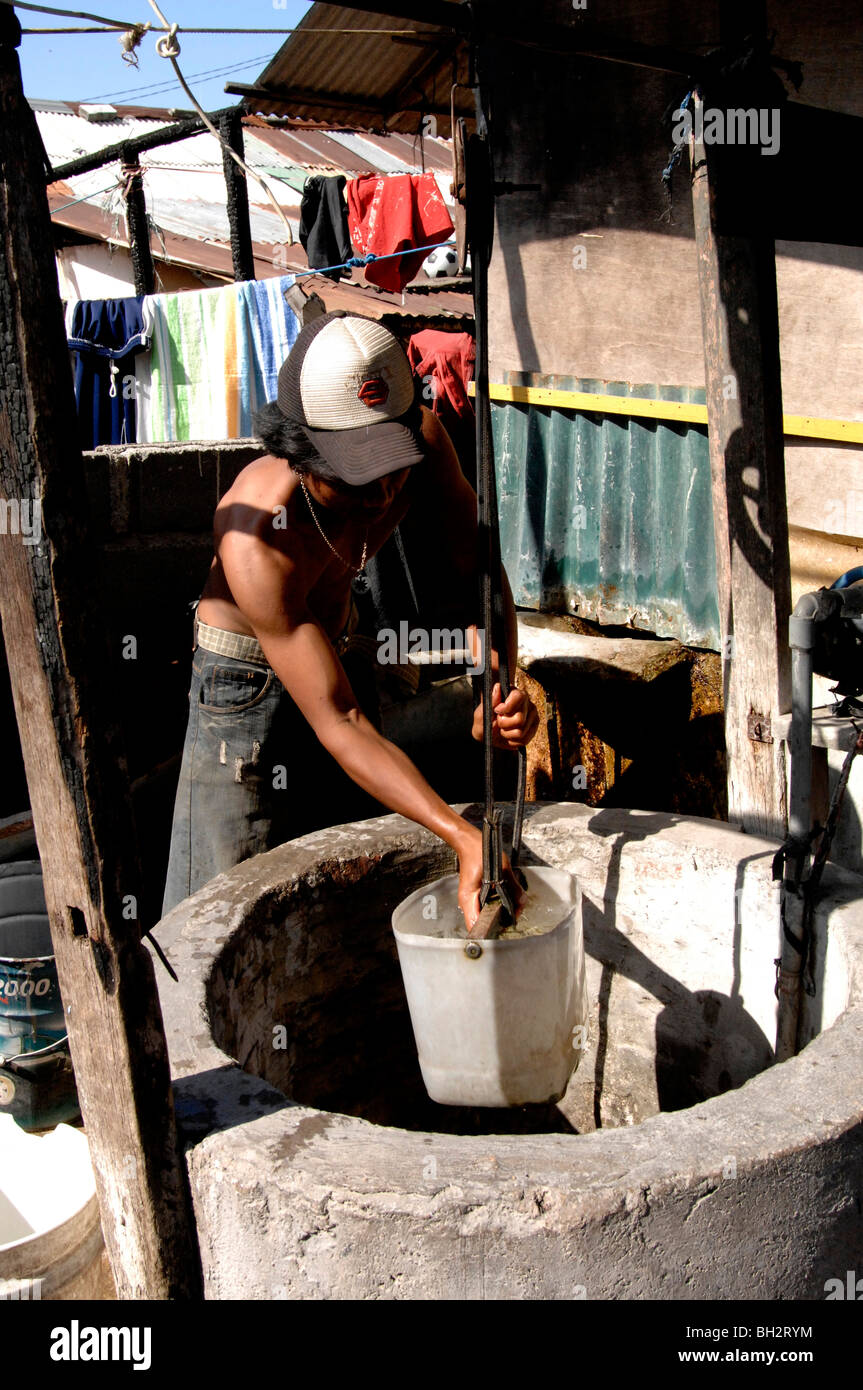 pulling water out of the well , kuta muslim community, kuta , bali ...
