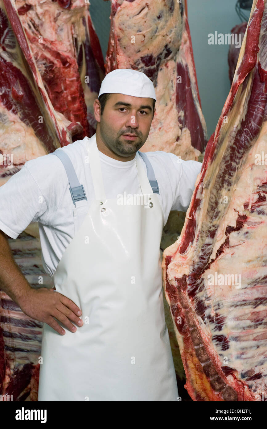 Butcher with half a cow in his arm Stock Photo - Alamy
