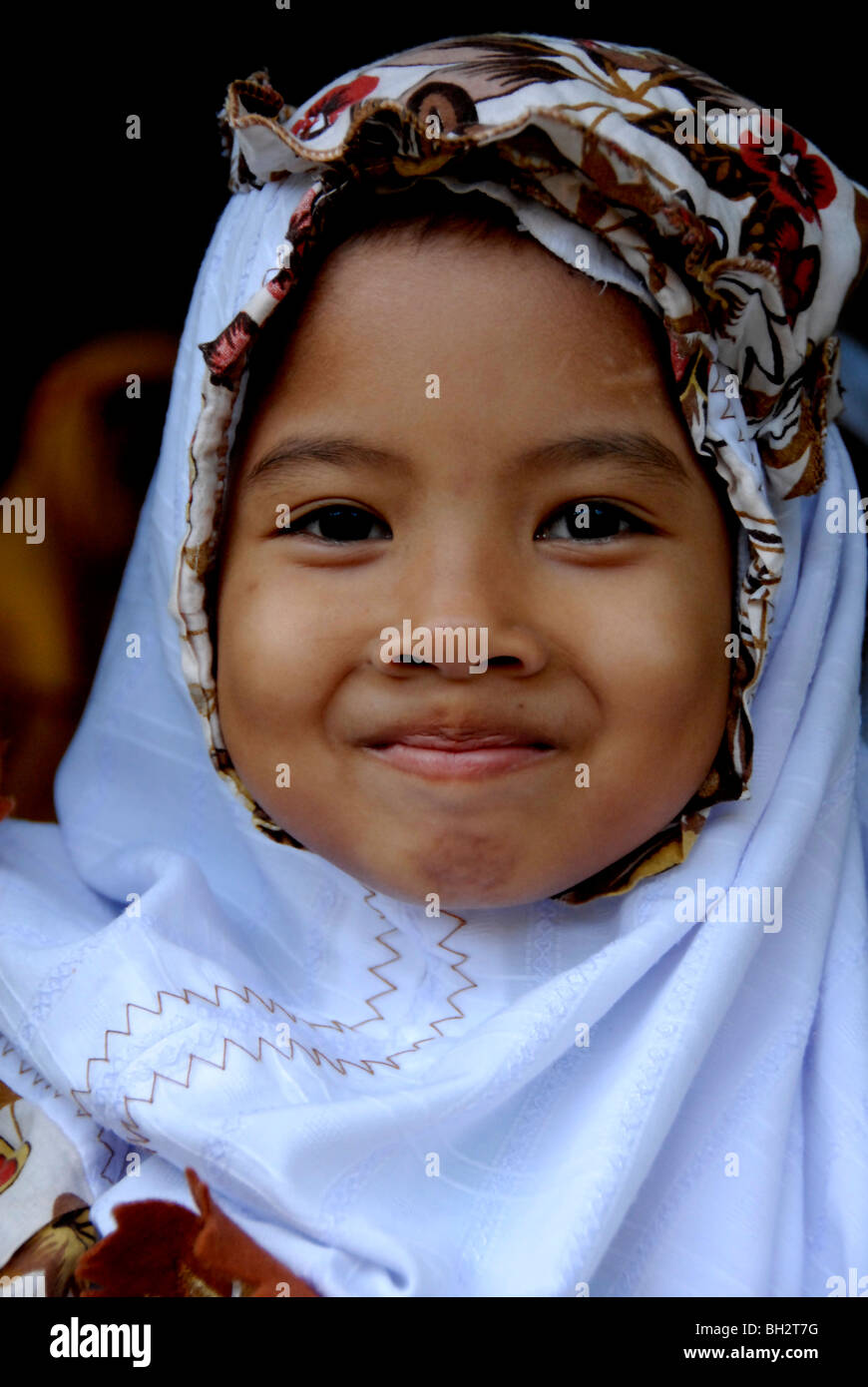 cute little smiling balinese muslim gril in bali, indonesia Stock Photo ...