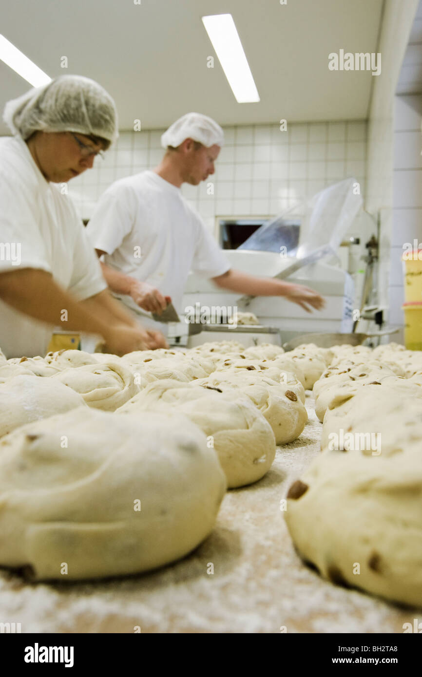 Two people in a bakery with rolls Stock Photo - Alamy