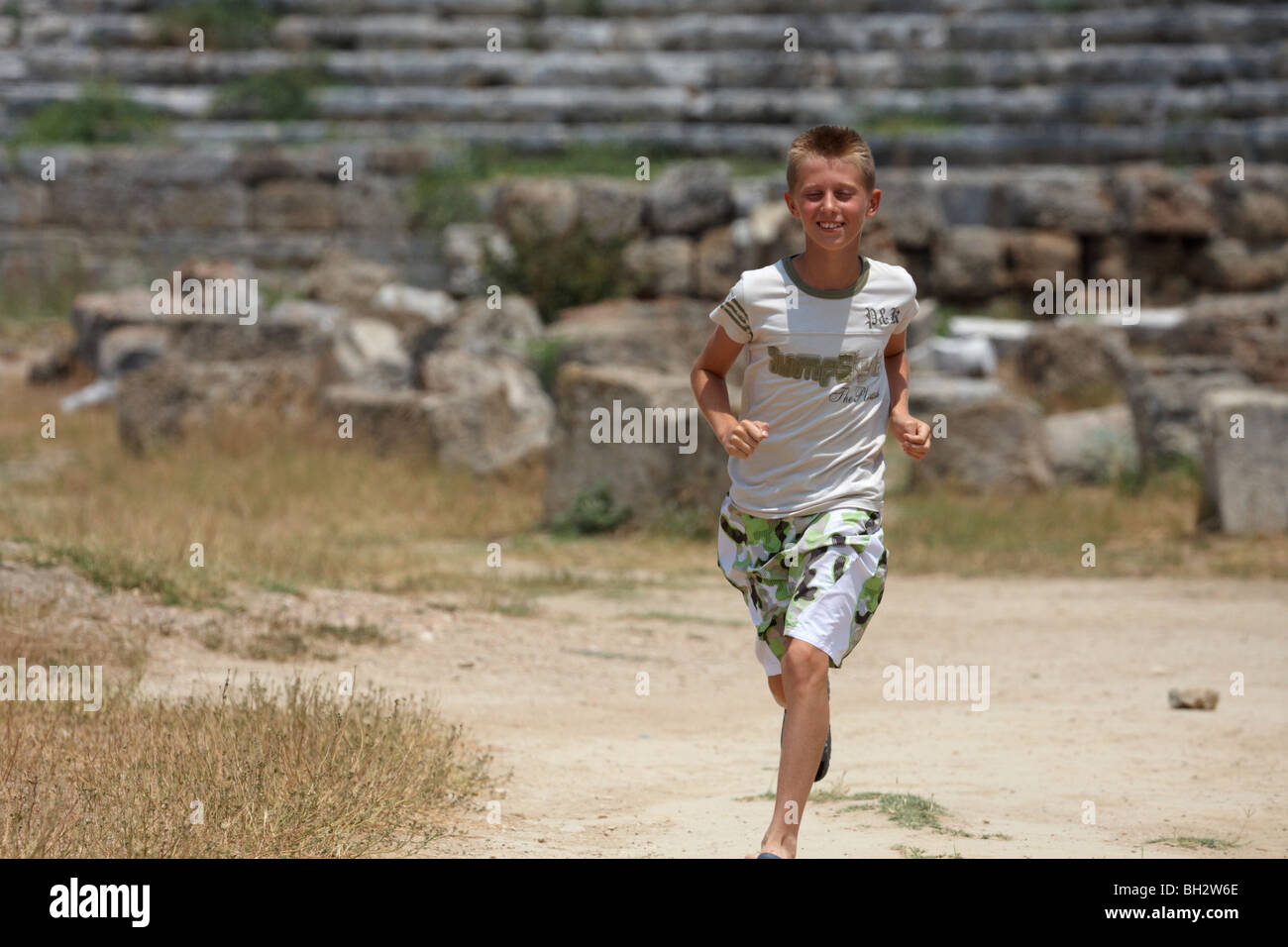 boy running through the ancient stadium Stock Photo - Alamy