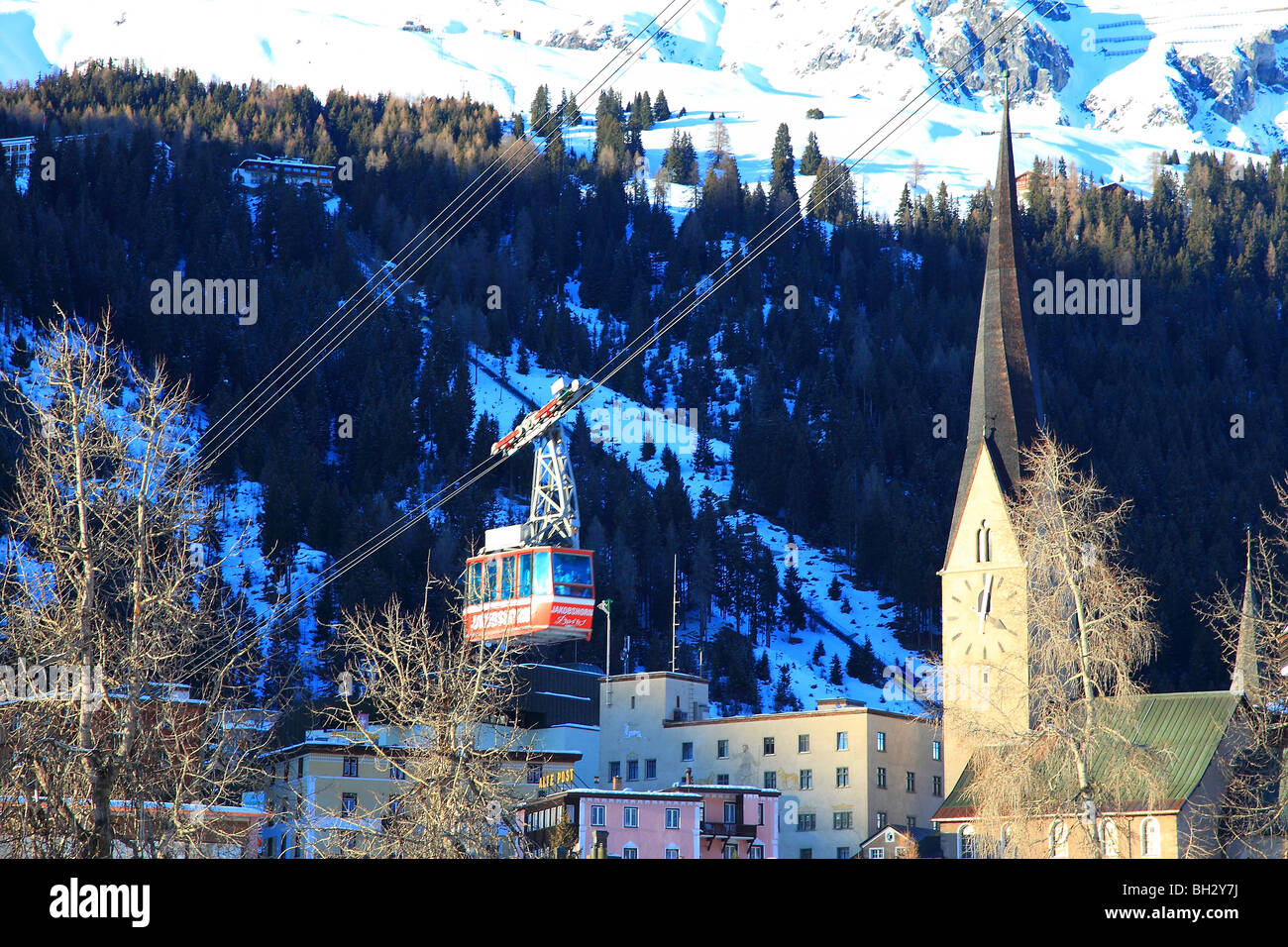 St. John Church in Davos town and gondola Jakobshorn, Switzerland Stock ...