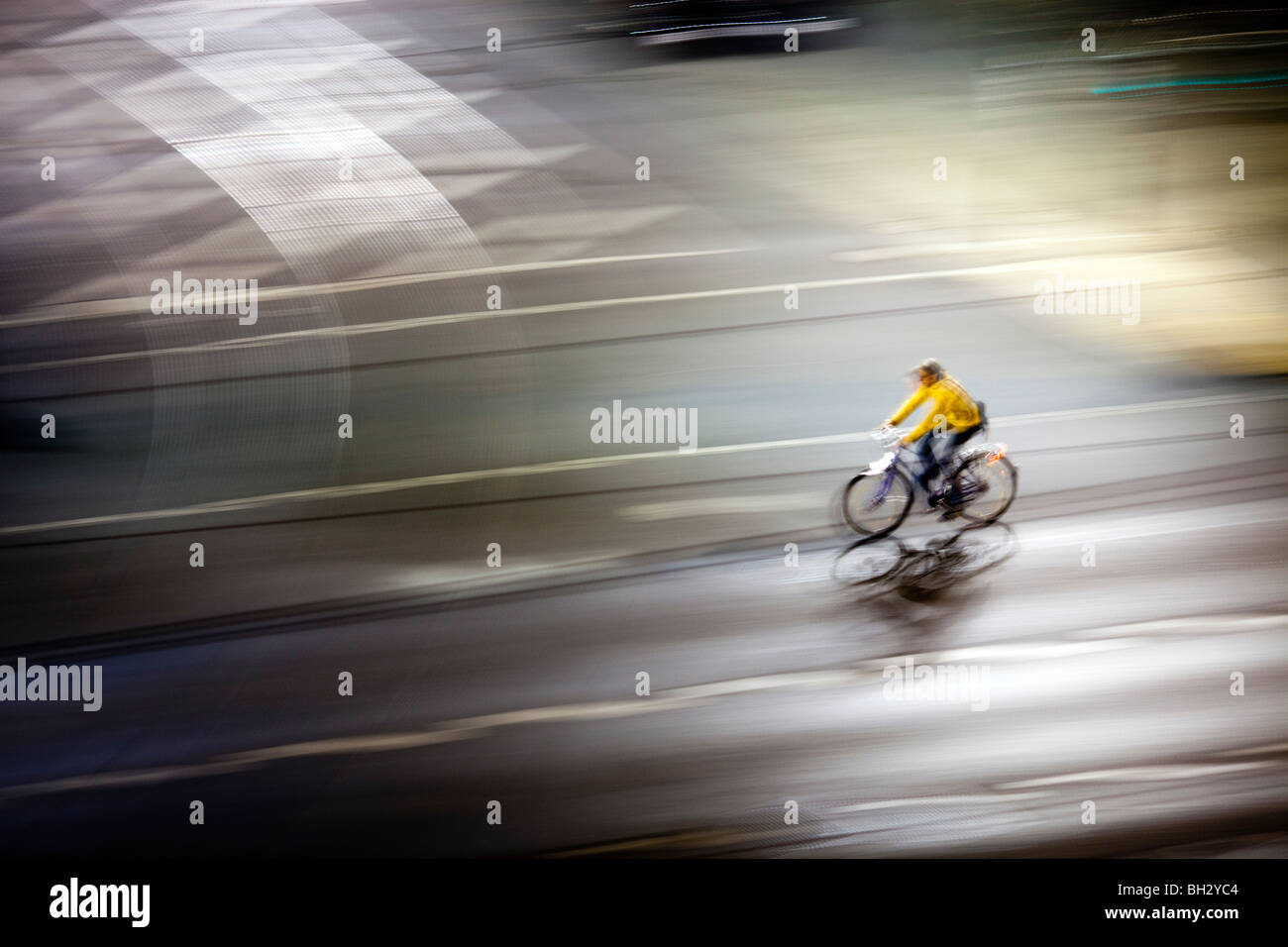 Panning shot of a cyclist by night Stock Photo - Alamy