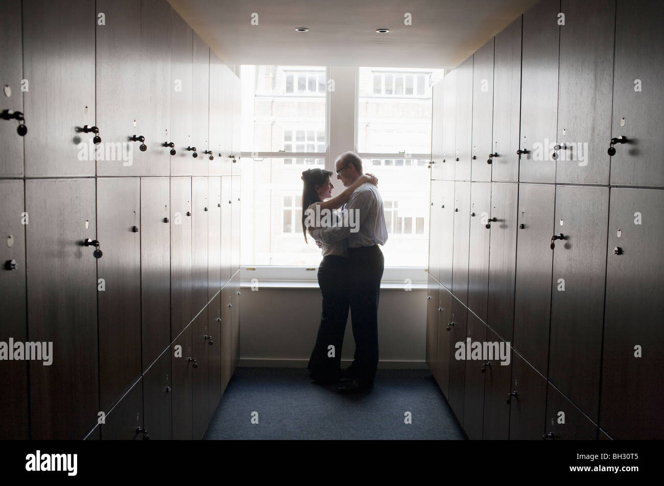 Office romance hiding hi-res stock photography and images - Alamy