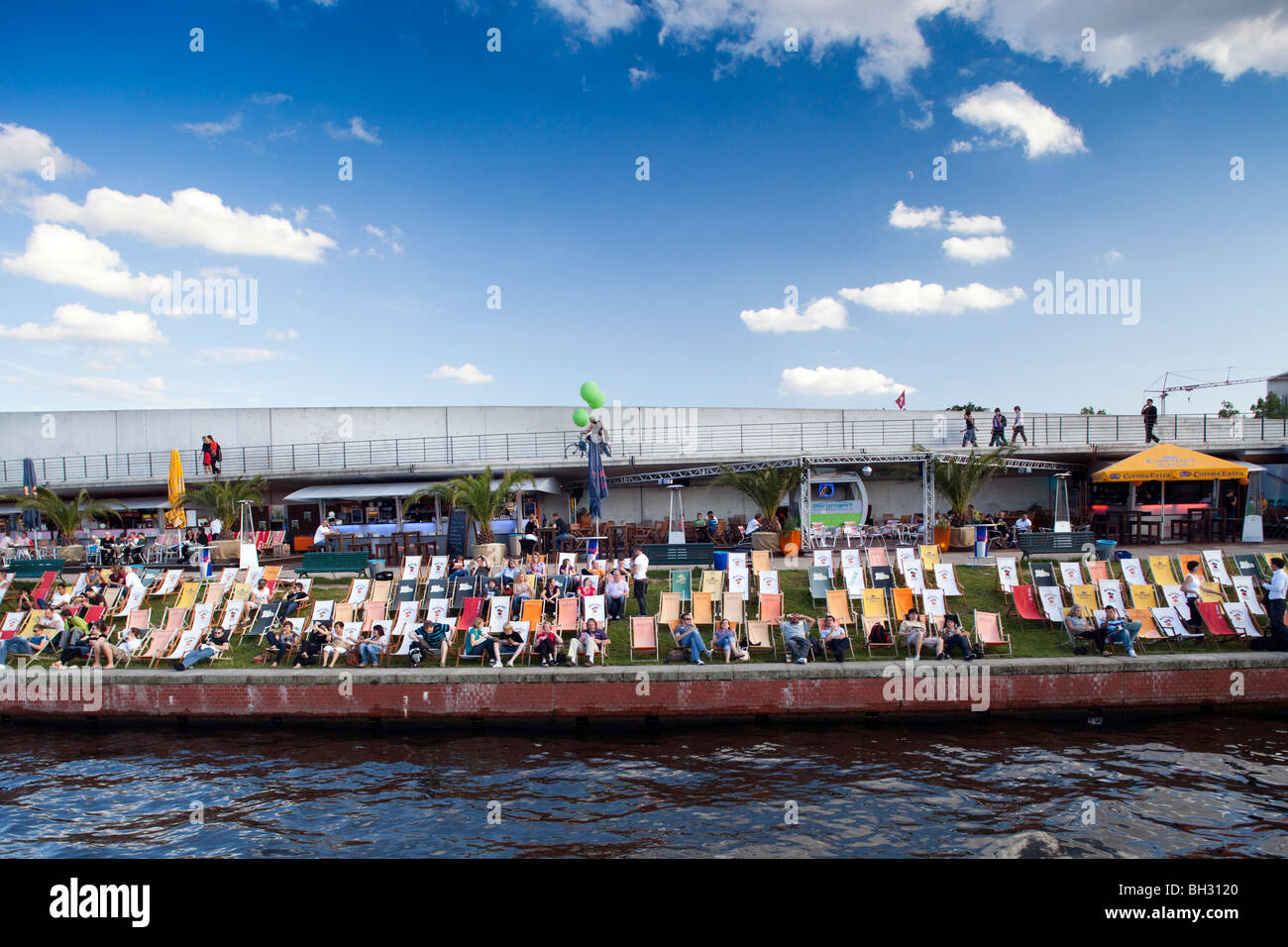 Open air bar on the Spree river bank by Gustav-Heinemann bridge, Berlin ...