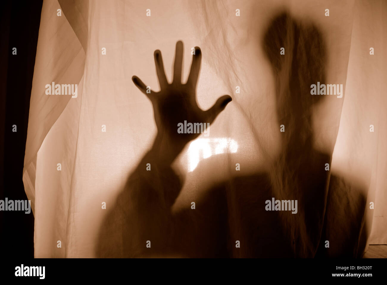 SILHOUETTE BEHIND THIN FABRIC Stock Photo - Alamy