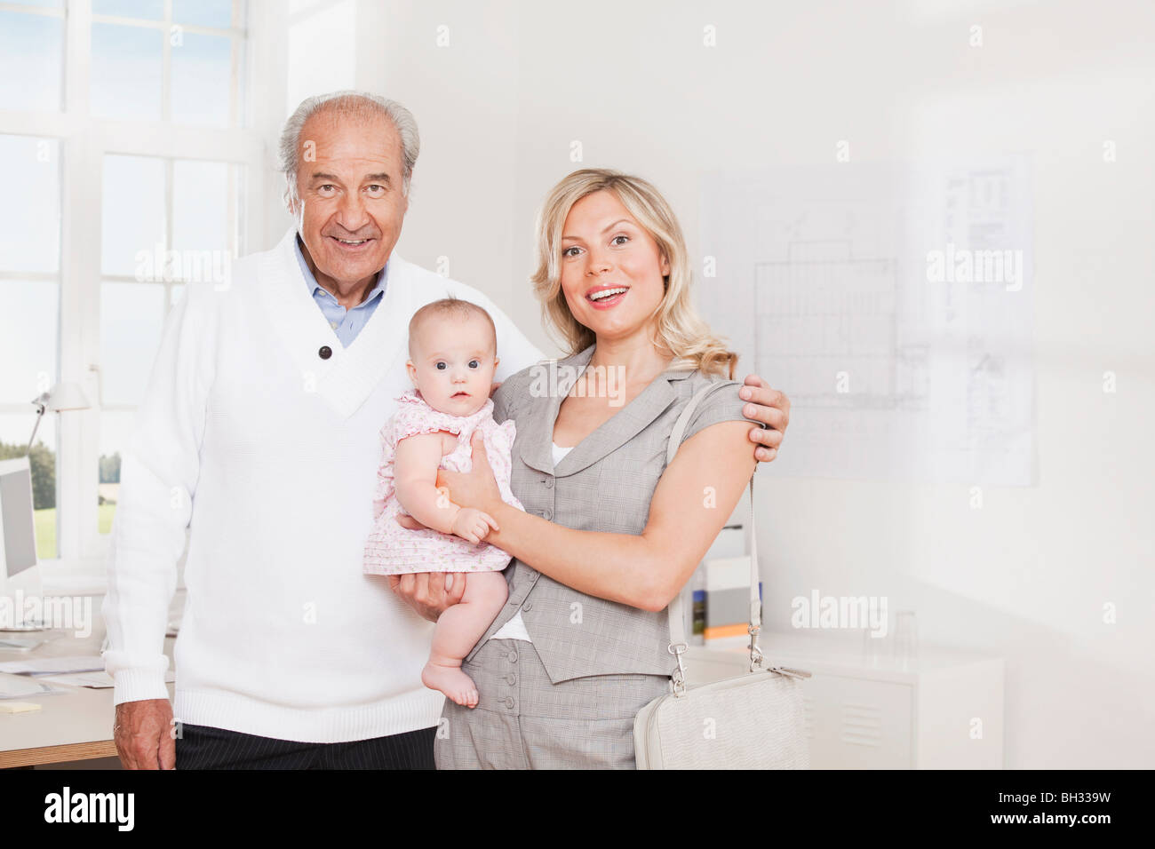 Woman with baby and her boss Stock Photo - Alamy
