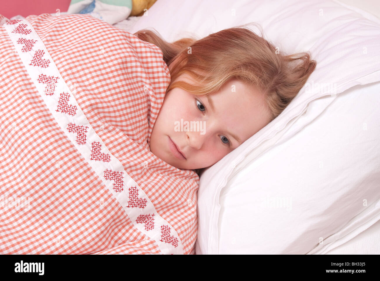 Young girl awakes in her bed at night UK Stock Photo - Alamy