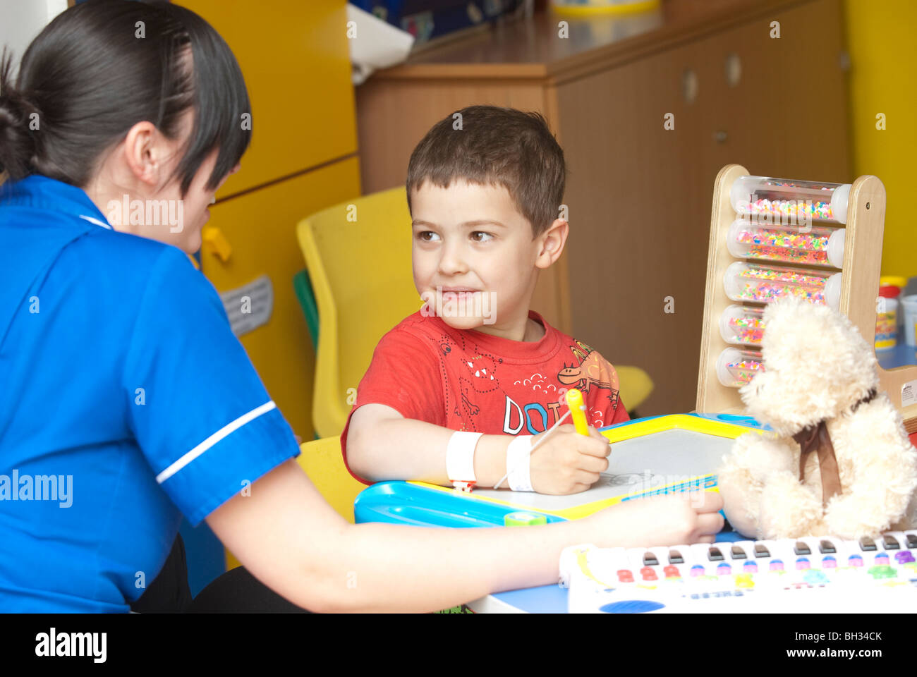 Nurse works with a young boy in Hospital Stock Photo - Alamy