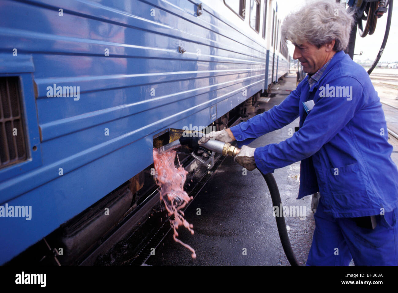 Caen railway worker filling a train with diesel hi-res stock ...