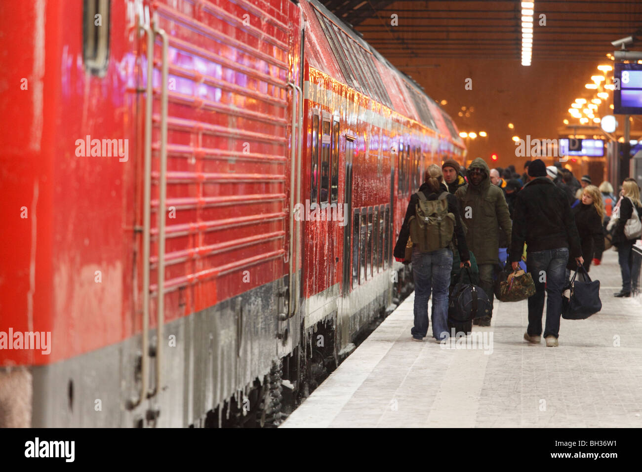 travelers boarding an icy train, winter conditions on the roofed ...