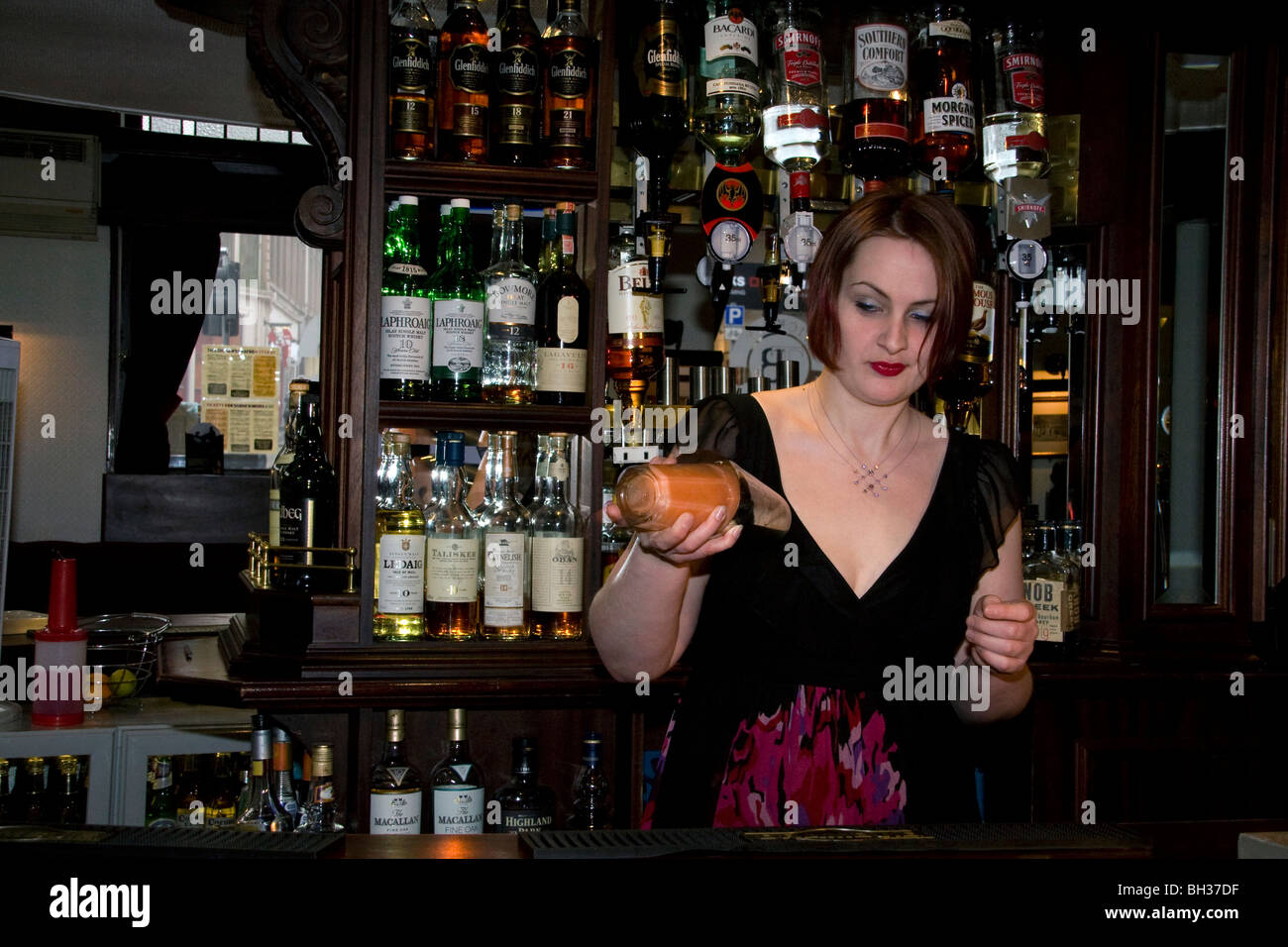 Female model standing behind bar hi-res stock photography and images ...