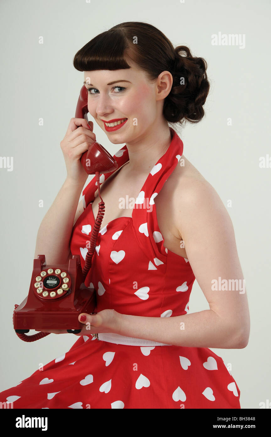 Girl in 1950s dress holding a telephone phone Stock Photo - Alamy
