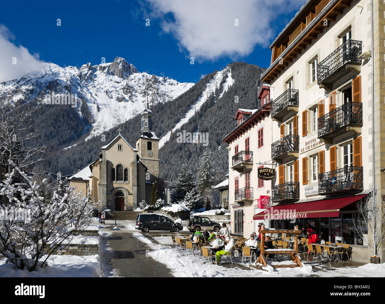 Hotel and bar with church and Le Brevent ski area behind, Chamonix Mont ...