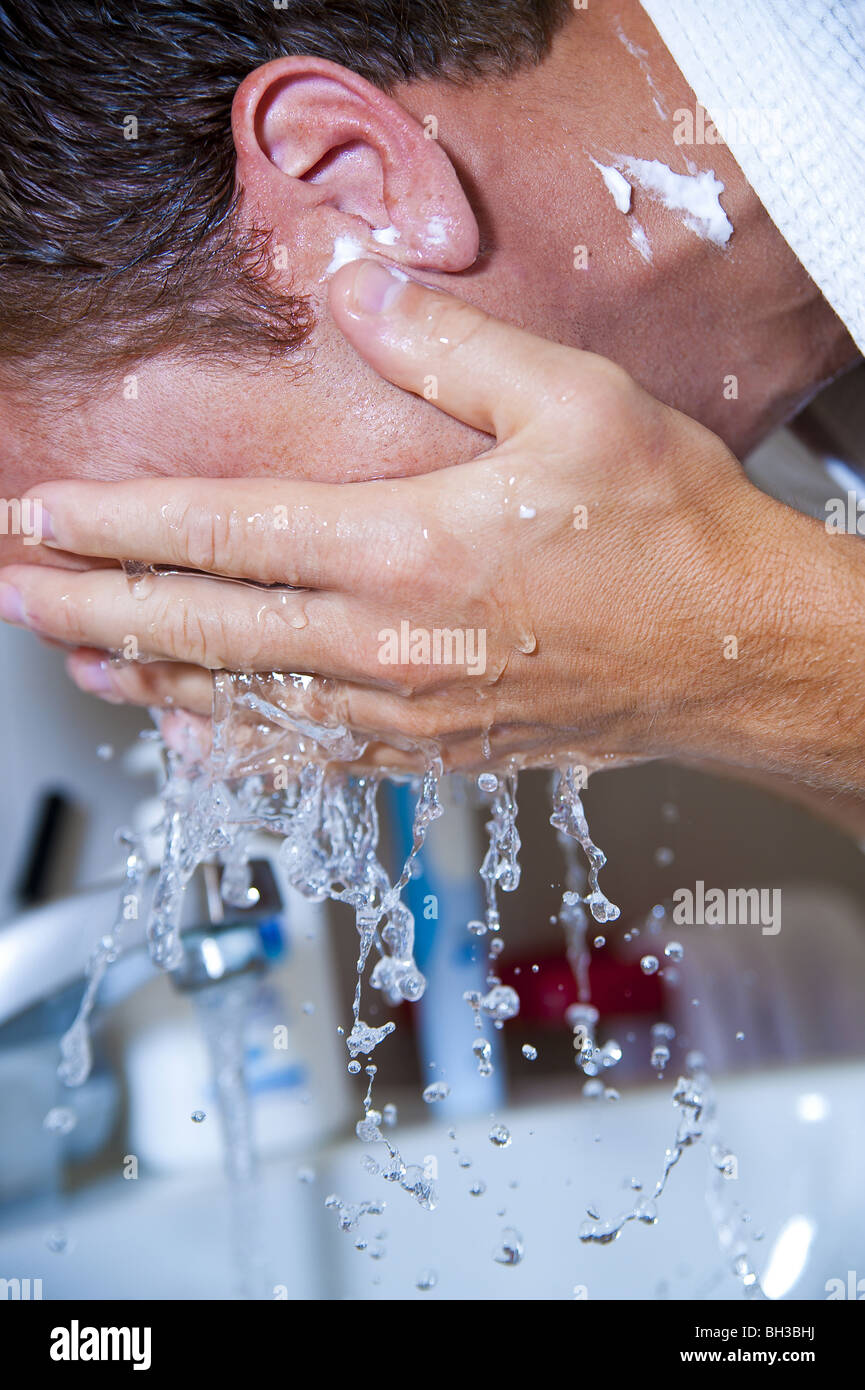 Man washing face in sink Stock Photo - Alamy