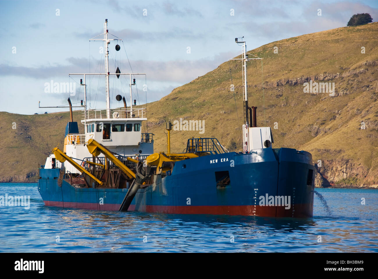 A small split hopper dredger at work in Lyttelton Harbour, New Zealand ...