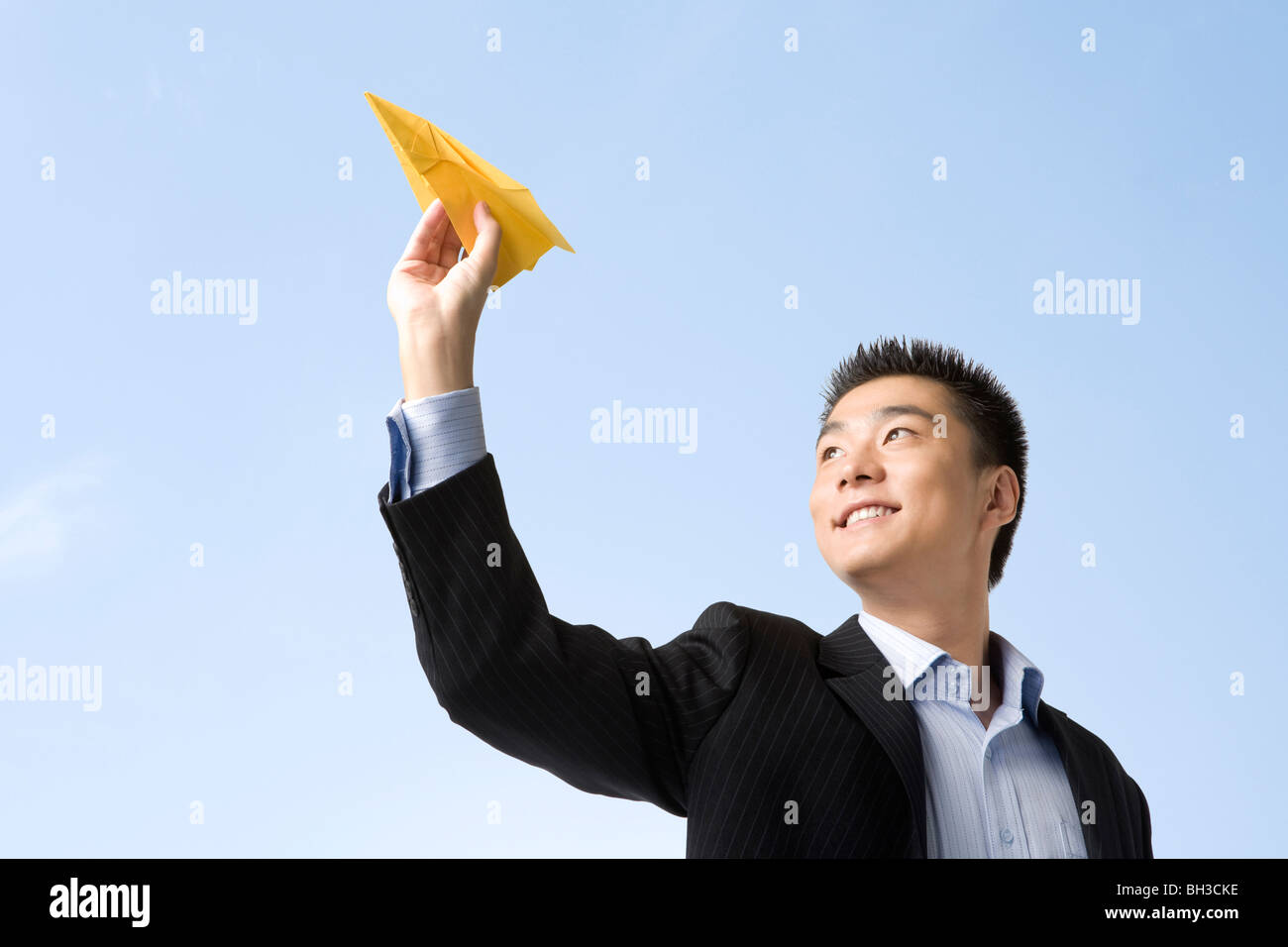 Businessman flying paper airplane Stock Photo - Alamy