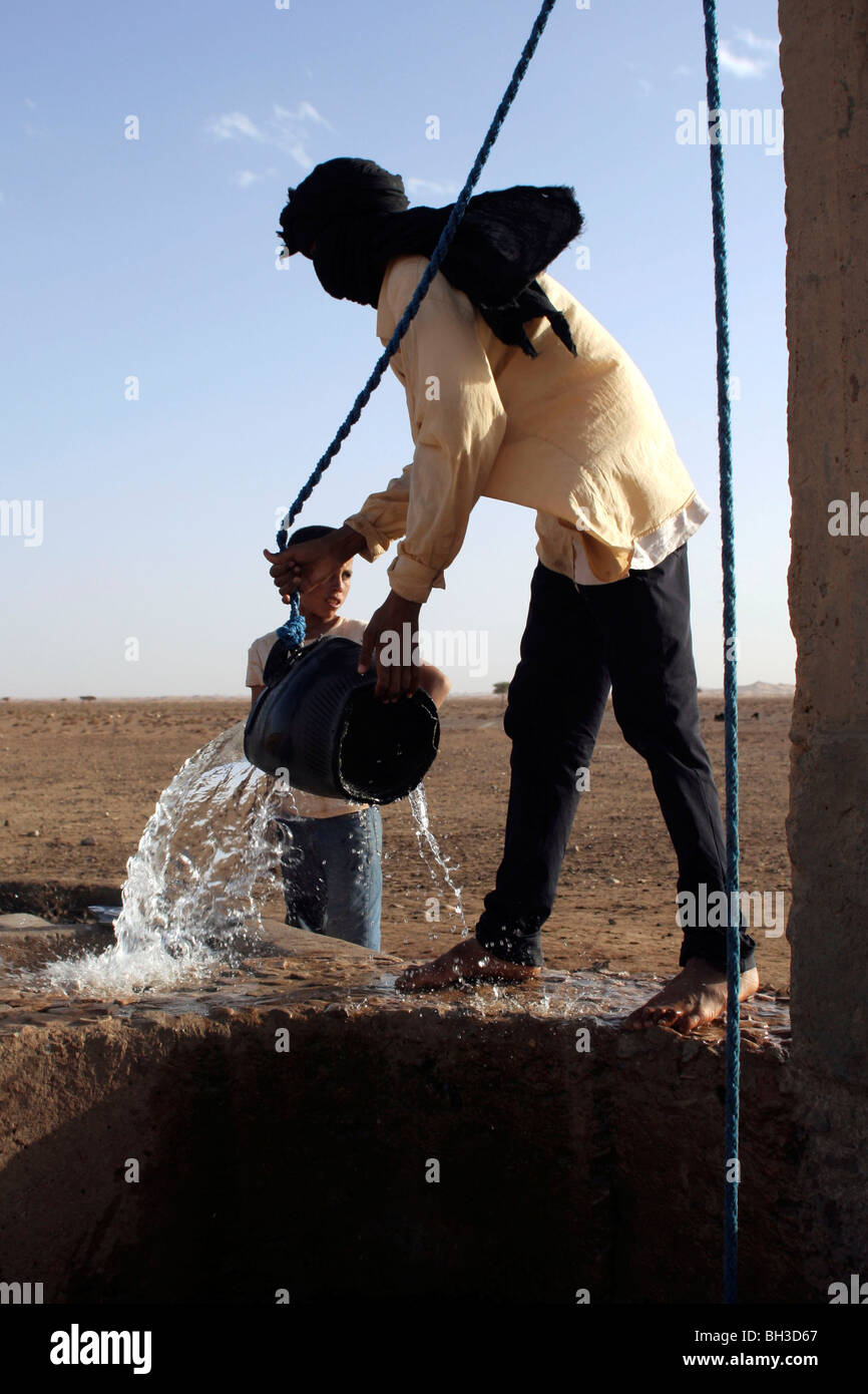 Child drawing water from well hi-res stock photography and images - Alamy