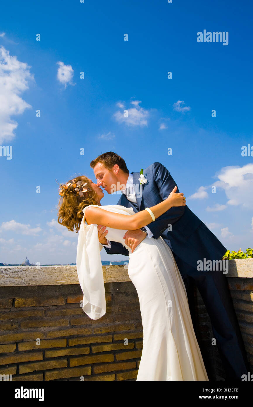 Young bride and groom kissing Stock Photo - Alamy