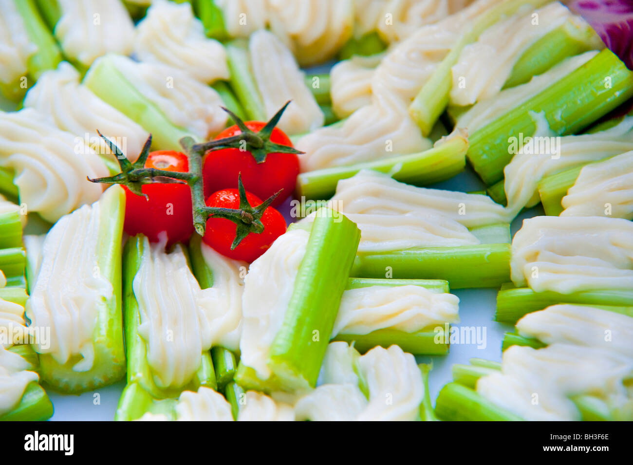 Close-up of celery with mayonnaise with cherry tomatoes Stock Photo - Alamy