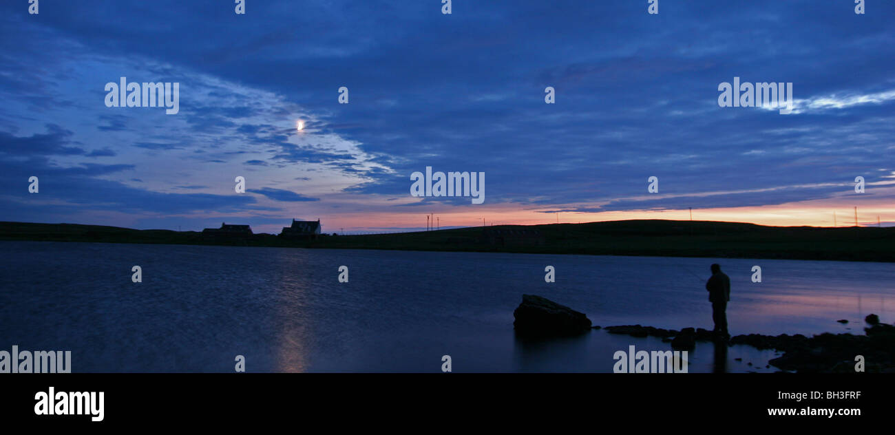 Midnight fishing under a Uist sky Stock Photo - Alamy