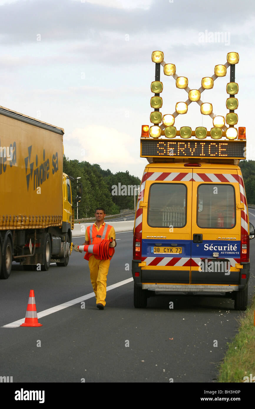 Seine et marne removing the cones marking a broken down vehicle hi-res ...