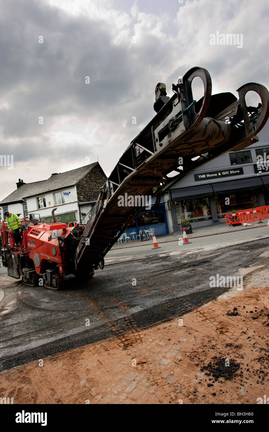 Preparing road by stripping old road surface before re tarmacking road ...