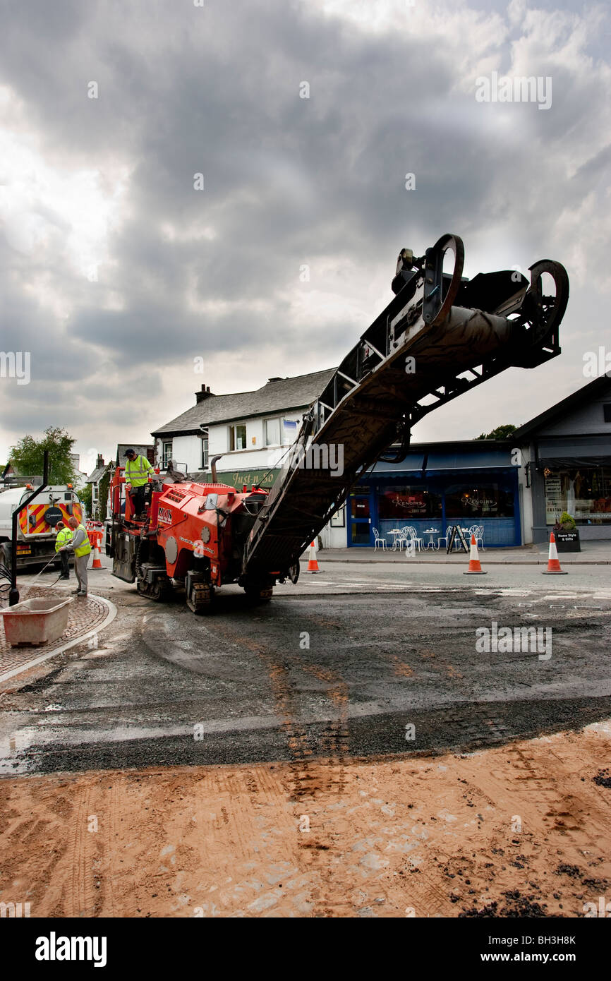 Preparing road by stripping old road surface before re tarmacking road ...