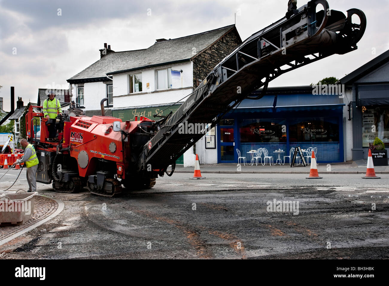 Preparing road by stripping old road surface before re tarmacking road ...
