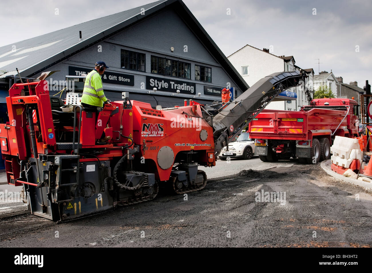 Preparing road by stripping old road surface before re tarmacking road ...