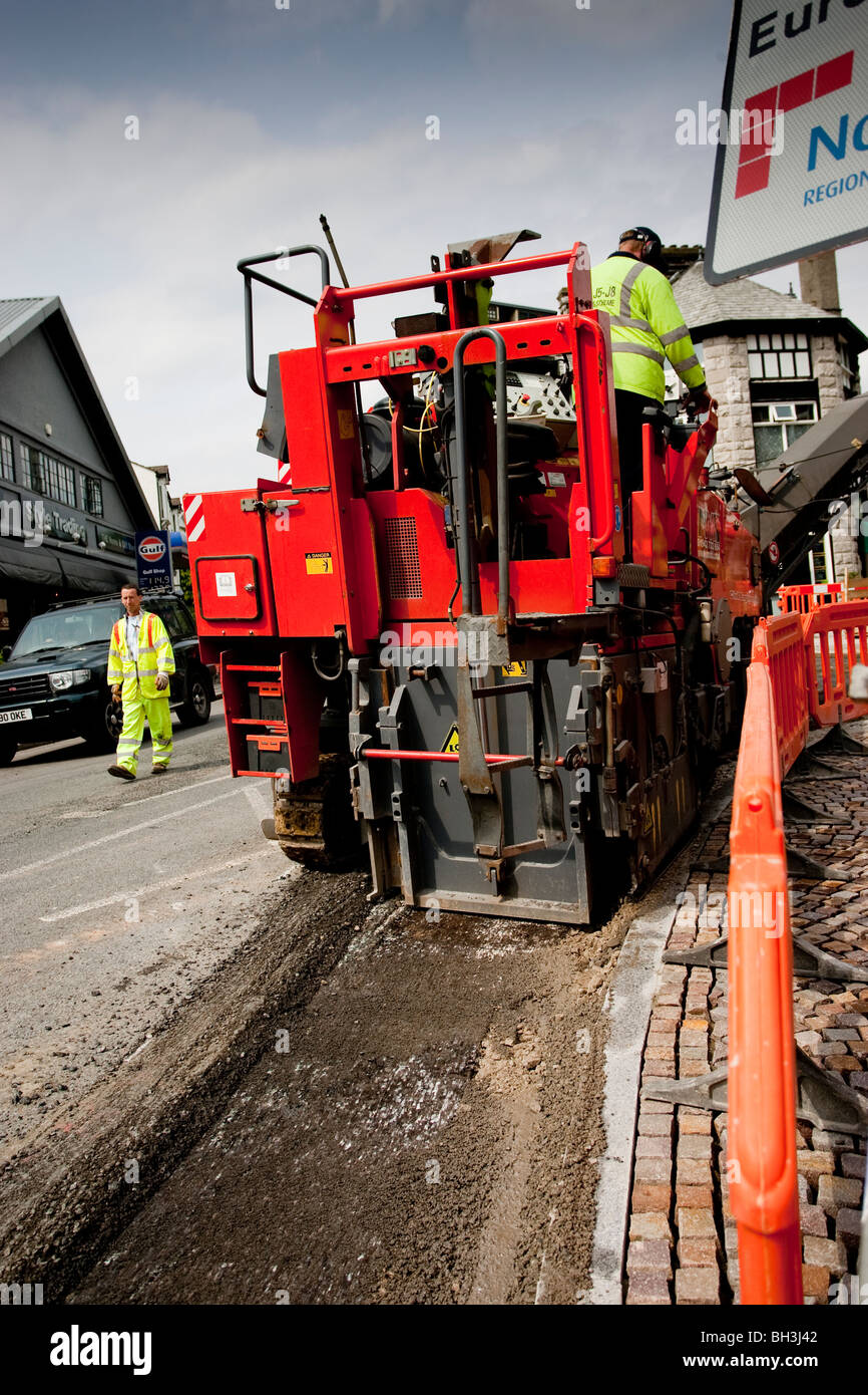 Preparing road by stripping old road surface before re tarmacking road ...