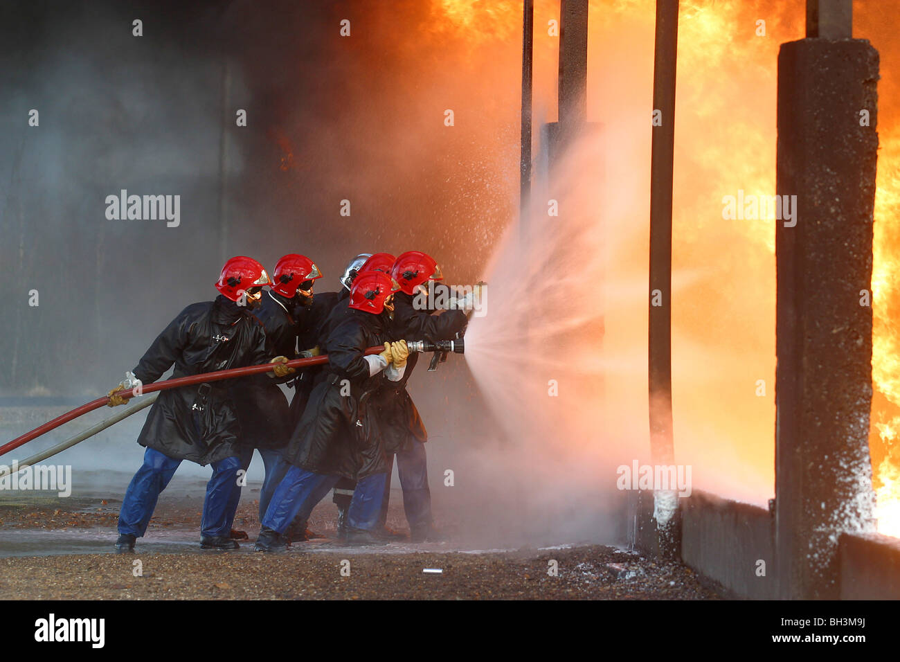 FIREFIGHTERS IN ACTION FOR TRAINING EXERCISE IN HYDROCARBON FIRE ...