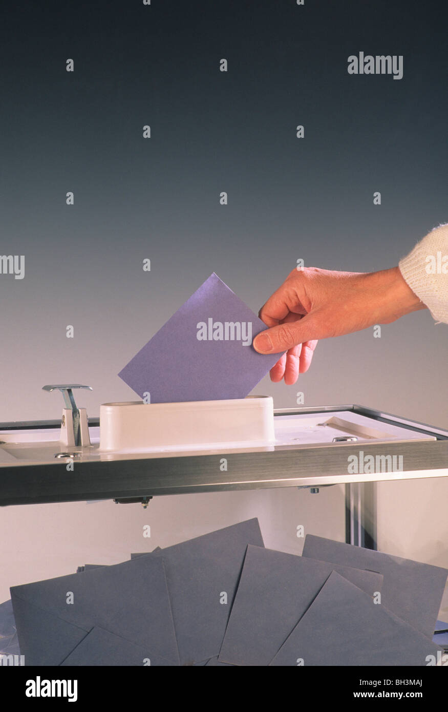 Voting process in a democratic election with a hand casting a ballot ...