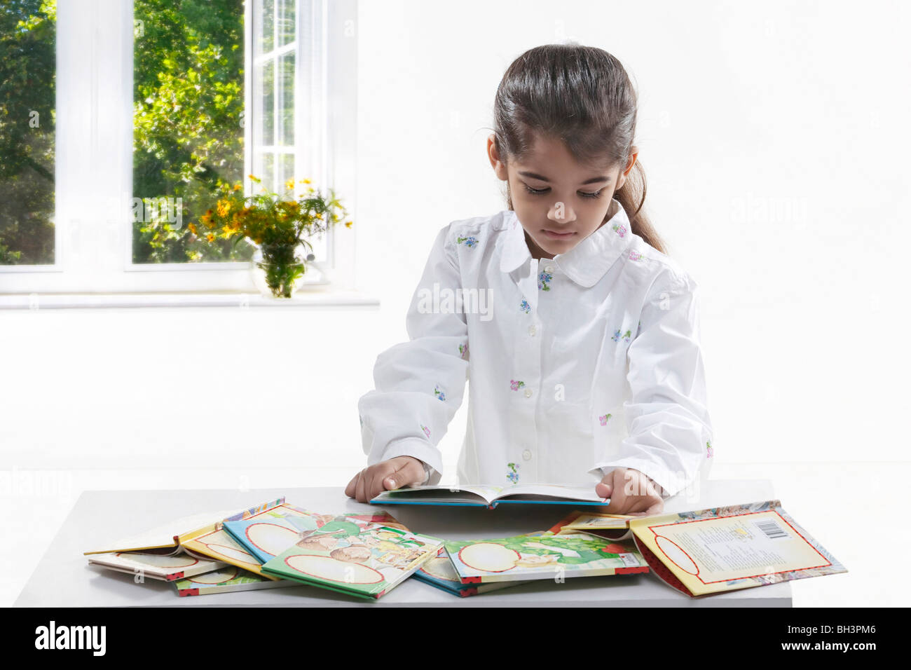 Girl reading a book Stock Photo - Alamy