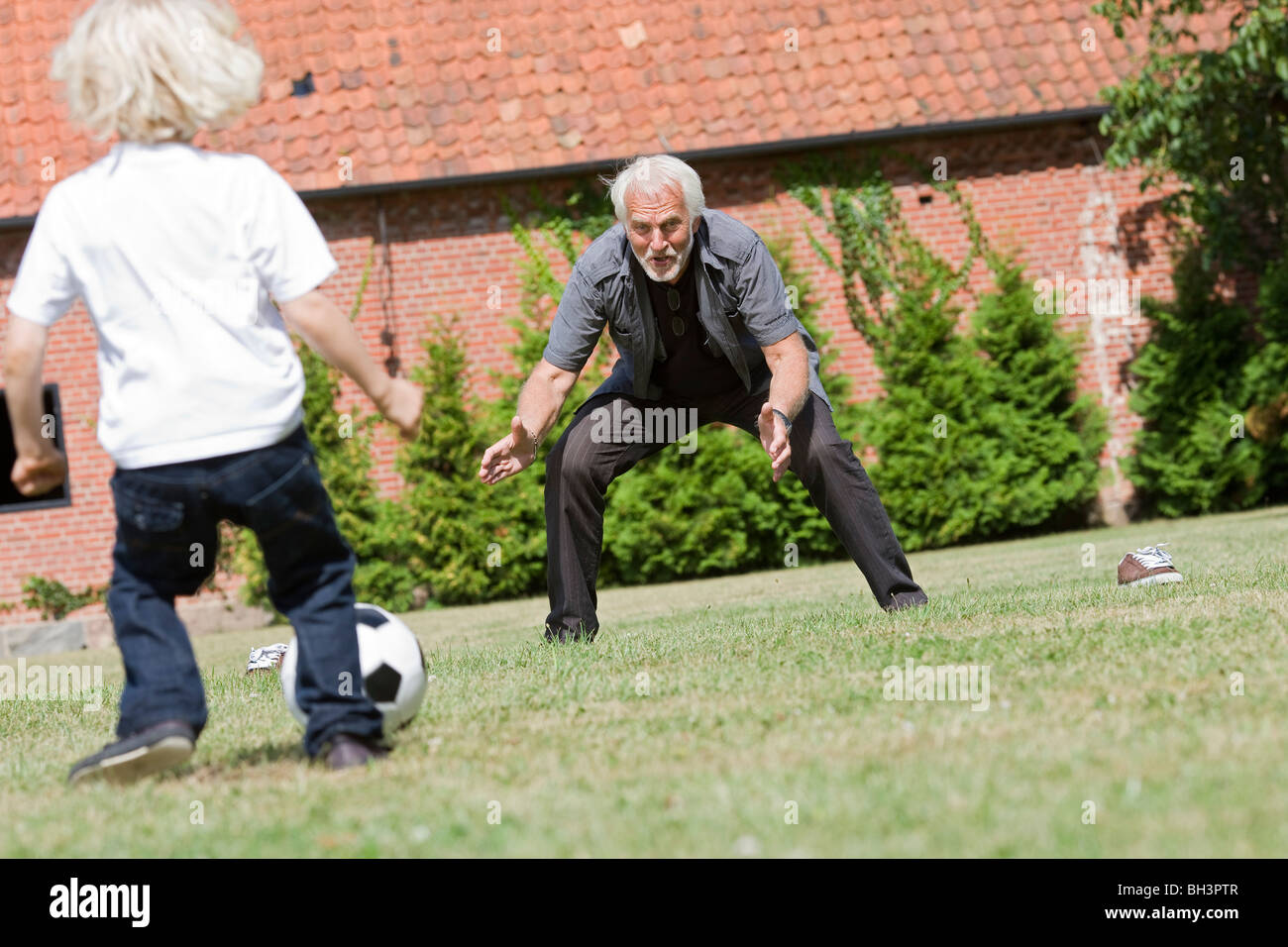 grandfather and child playing football Stock Photo - Alamy