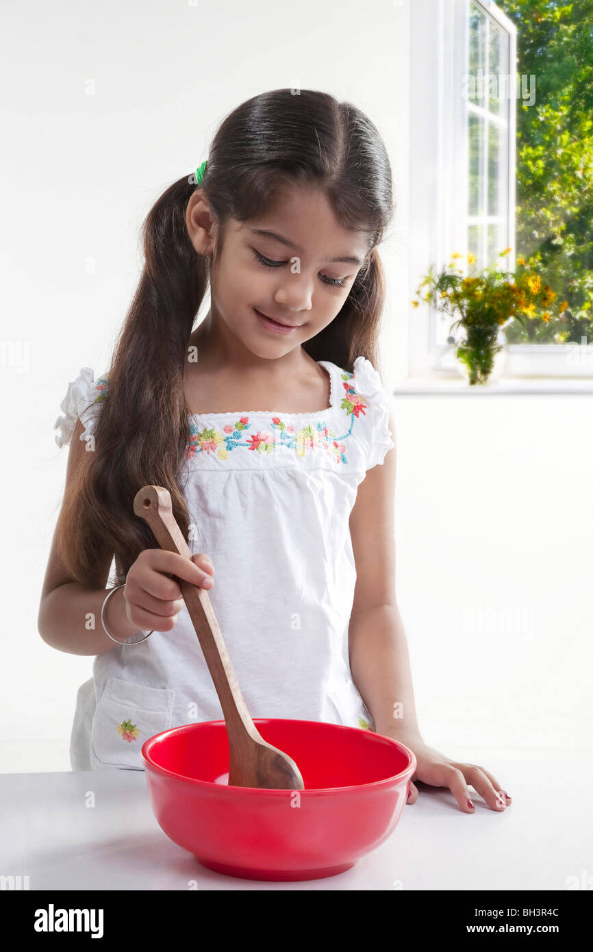 Girl with a spatula and a bowl Stock Photo - Alamy