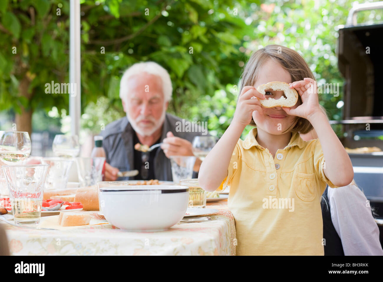 little girl with peace of bread Stock Photo - Alamy