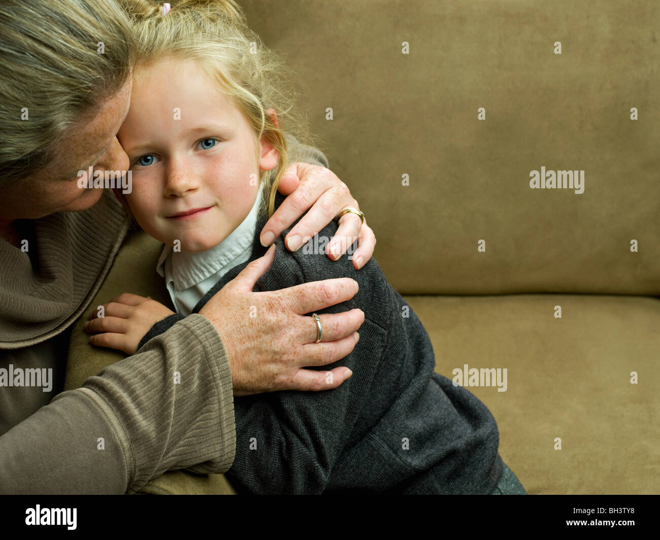 A young girl being hugged by her mum Stock Photo - Alamy