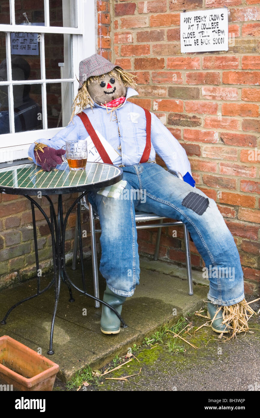 Traditional scarecrow sitting with a pint outside pub at 2009 Flamstead ...