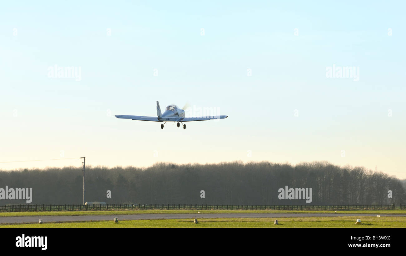 Light aircraft taking off and rising into the blue sky Stock Photo - Alamy