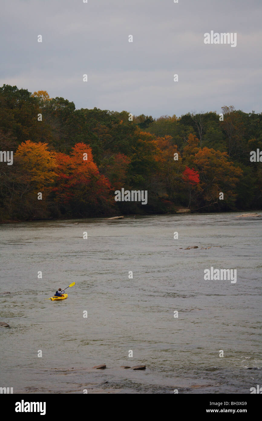 KAYAKER(S) PADDLING A RIVER ENJOYING THE FALL COLOR IN THE TREES ...